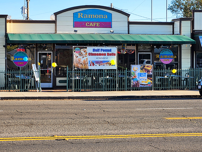 The promised land of breakfast awaits behind this cheerful facade, where that banner proudly announces what pilgrims travel miles to taste.