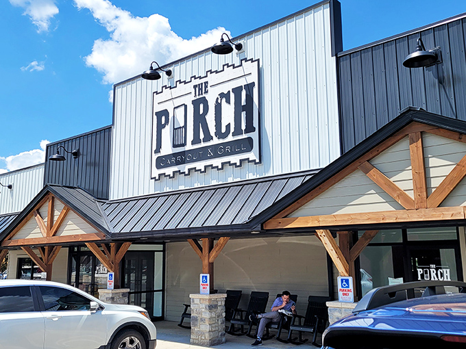 The modern rustic charm of The Porch welcomes hungry visitors with its distinctive wooden beams and inviting covered entrance.