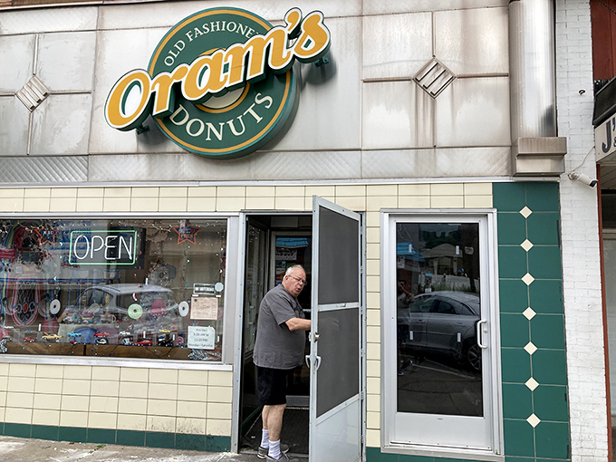 The green and yellow beacon of hope for carb enthusiasts everywhere. Oram's iconic sign promises old-fashioned delights that modern donuts can only dream of becoming.