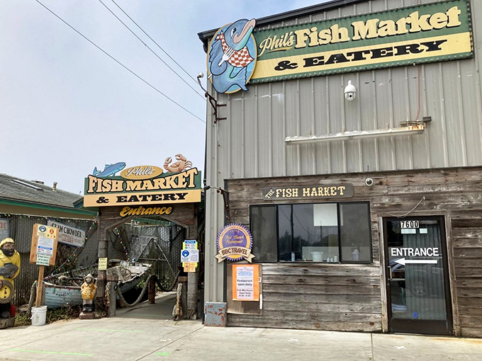 The unassuming exterior of Phil's Fish Market is like finding a treasure chest disguised as a toolshed. Seafood magic happens behind these weathered wooden walls.