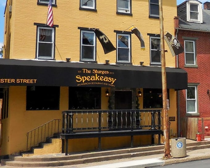 The bright yellow facade of Sturges Speakeasy stands out like a culinary beacon in Harrisburg, promising delicious secrets within rather than illicit hooch.