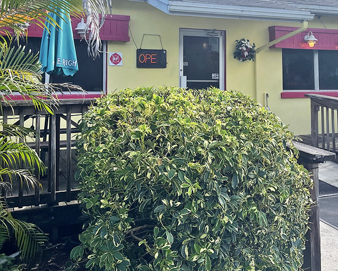 The unassuming exterior of Leo's French Toast House, where palm trees and a wooden ramp welcome you to one of Alva's best-kept culinary secrets.