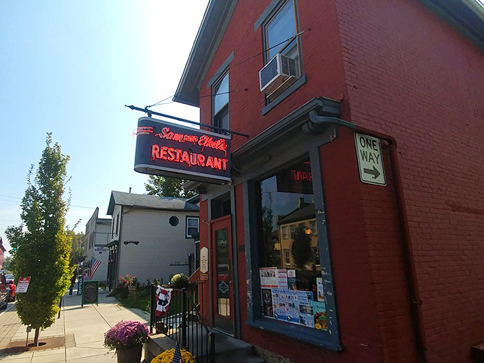 The iconic red brick exterior of Sam and Ethel's stands like a beacon of breakfast hope on Tipp City's Main Street, promising comfort inside those unassuming walls.