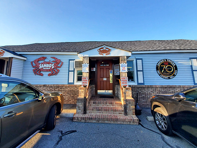 The iconic blue exterior with its bold red crab logo promises seafood treasures within &ndash; Delaware's ultimate "come as you are" dining destination.