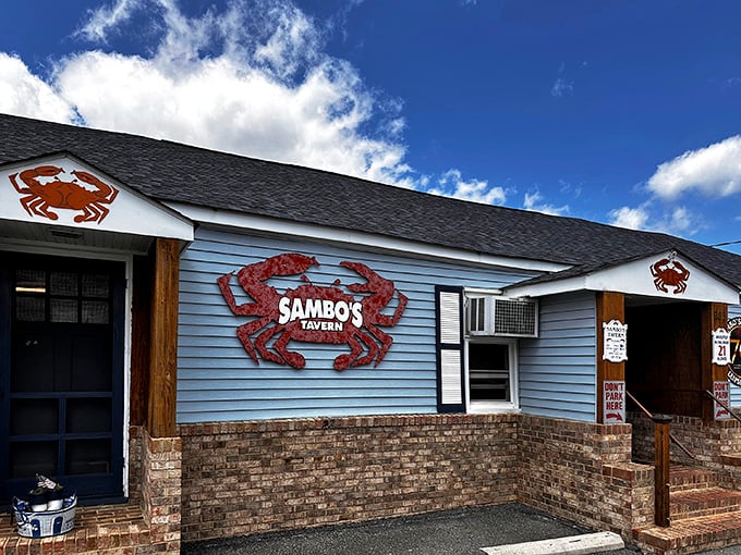 The iconic blue exterior of Sambo's Tavern, where those giant red crab signs aren't just decoration&mdash;they're a delicious promise of what awaits inside.