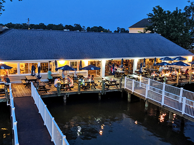 The welcoming exterior of Skipper's Pier beckons like a coastal postcard come to life, complete with cheerful flower pots and palm trees that whisper, "Vacation starts now."