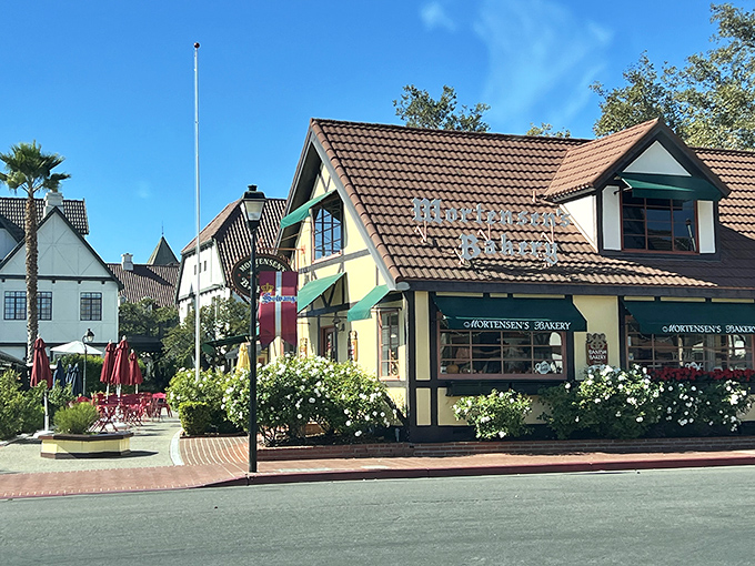 Mortensen's iconic yellow and timber-framed exterior stands as a beacon of Danish tradition in Solvang, promising buttery delights beneath that distinctive terracotta roof.