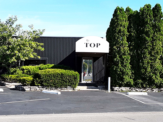 The iconic black and white striped exterior of The Top Steak House stands as Columbus's temple to timeless dining, promising carnivorous delights within.