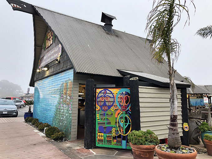The iconic A-frame structure of Harbor Hut stands proudly against Morro Bay's blue skies, promising seafood treasures within its wooden walls.