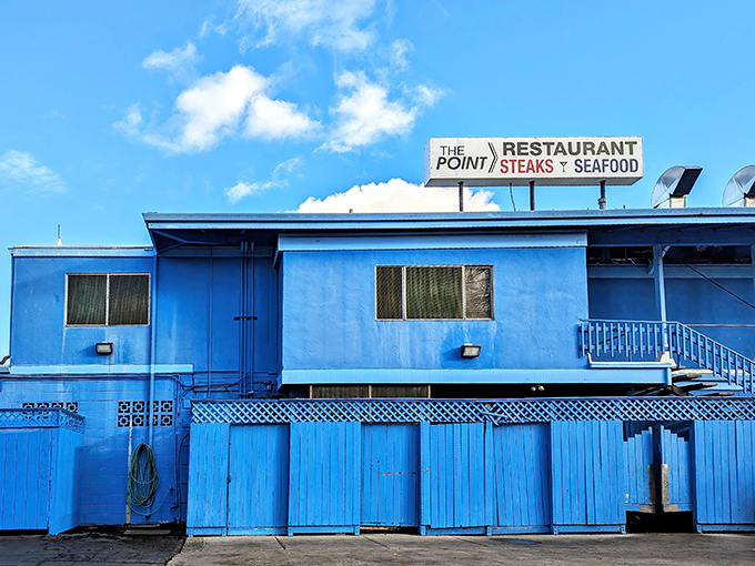 The distinctive blue exterior of The Point Restaurant stands like a beacon for hungry travelers&mdash;California's answer to a coastal lighthouse with seafood instead of warnings.