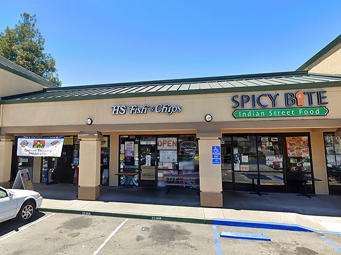 Strip mall treasure hunting at its finest! HS Fish & Chips shares space with Spicy Bite, hinting at the British-Indian fusion magic awaiting inside.