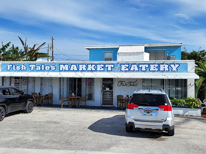 The bright blue exterior of Fish Tales stands out like a delicious mirage on Marathon's sun-drenched landscape, promising seafood treasures within.