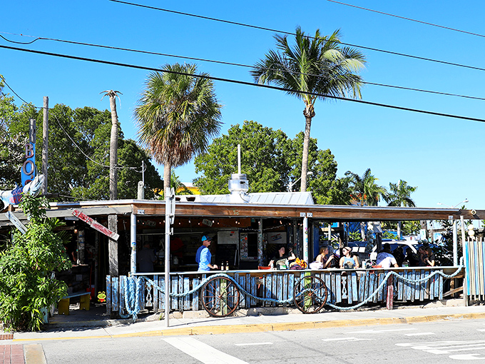 The iconic wooden fish sign of B.O.'s Fish Wagon stands sentinel against the Key West sky, promising seafood salvation to hungry travelers.