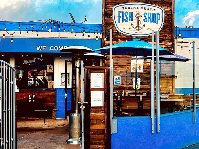 The blue and white exterior beckons like a maritime mirage, promising seafood treasures behind that wooden sign and welcoming gate.