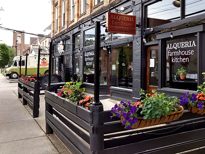 Alqueria's inviting exterior beckons with vibrant flower boxes and a sleek black facade. This farmhouse kitchen feels like Columbus's best-kept secret hiding in plain sight.
