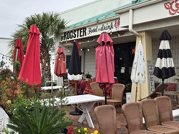 The Rooster's cheerful exterior with its vibrant red umbrellas is like a morning wake-up call that promises good things ahead.