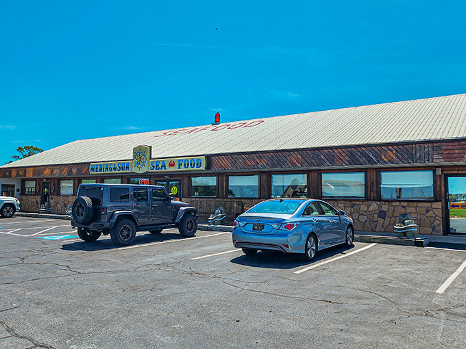 The unassuming exterior of Meding's Seafood beckons like a lighthouse for hungry travelers. That blue sign promises seafood salvation just off the highway. 