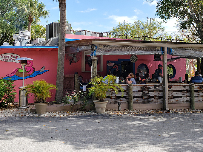That pink exterior isn't just a building—it's a promise of Florida fun wrapped in Caribbean color. The blue-trimmed windows peek out like portholes on this seafood sanctuary.