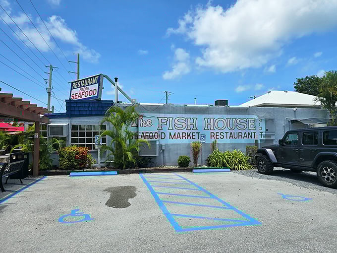 The blue exterior of The Fish House stands like a seafood beacon in Key Largo, complete with a marlin silhouette that practically screams "fresh catch inside!"