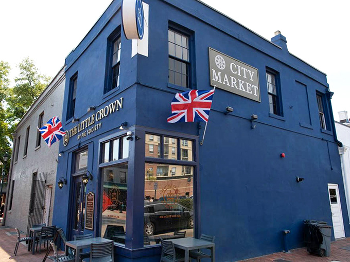 The Little Crown stands proudly in Savannah's City Market, its royal blue exterior and Union Jack flags announcing "British pies ahead!" like a delicious embassy.