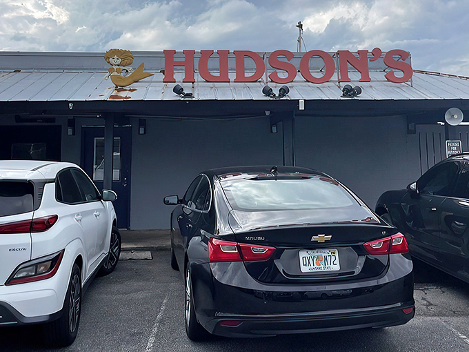 The iconic red Hudson's sign welcomes hungry visitors like a maritime beacon. No fancy frills needed when the seafood speaks for itself.