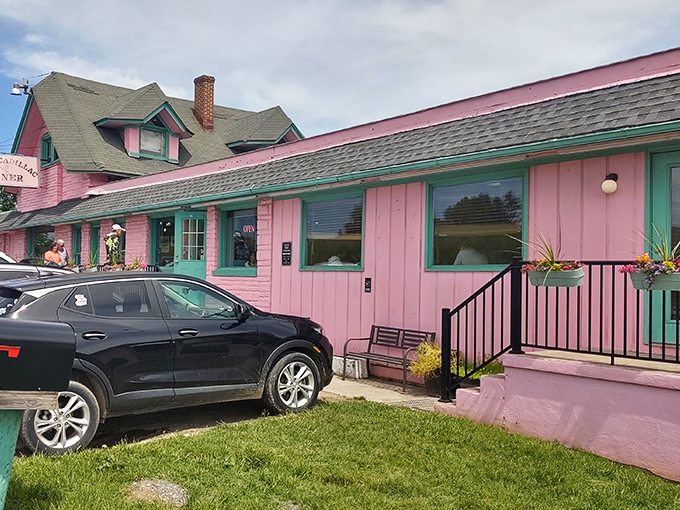 The Pink Cadillac Diner stands proudly against the Virginia sky, its bubblegum exterior and mint trim promising nostalgic delights within.