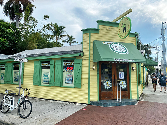The cheerful yellow building with green trim stands like a tropical beacon on the corner of Elizabeth and Greene Streets, promising citrusy salvation to all who enter.