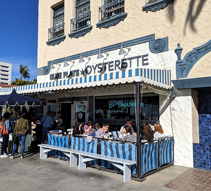 The blue-and-white striped awnings of Blue Plate Oysterette beckon like a maritime flag signaling "delicious food ahead" on Ocean Avenue.
