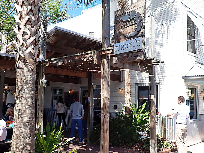 The unassuming white brick exterior of Timoti's Seafood Shak stands like a culinary lighthouse among Fernandina Beach's palm trees, promising seafood salvation to those in the know.