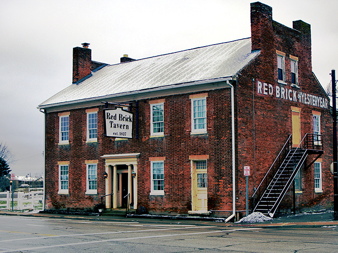 The historic Red Brick Tavern stands proudly along the National Road, its weathered fa&ccedil;ade a testament to nearly two centuries of American history and hospitality.