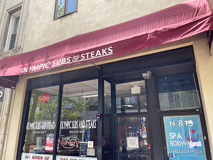 The burgundy awning beckons like a culinary lighthouse on Market Street, promising sandwich salvation to the hungry masses of Wilmington.