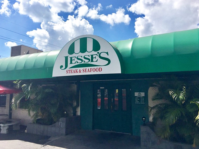 The iconic green awning of Jesse's Steak and Seafood stands like a beacon for hungry travelers. Florida's hidden steakhouse gem awaits behind those doors.