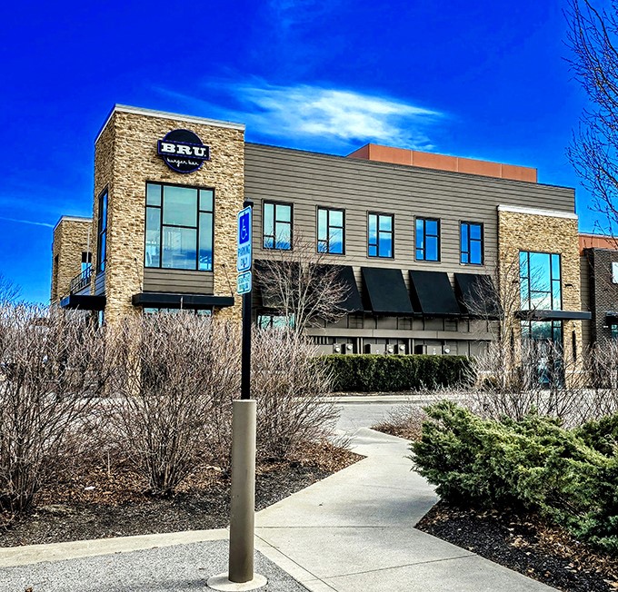 The modern stone fa&ccedil;ade of Bru Burger Bar stands like a culinary lighthouse in Westerville, beckoning hungry travelers with promises of gourmet comfort food.