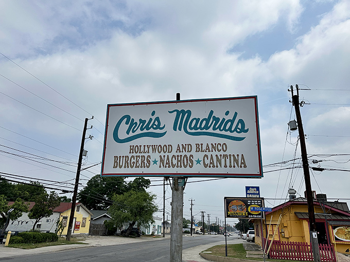 Welcome to cheese paradise! The colorful papel picado banners flutter above the entrance like a festive invitation to burger nirvana.