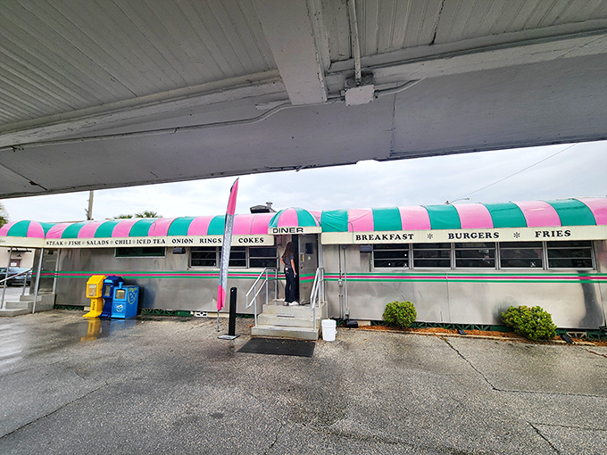 The iconic pink and green striped awning of Angel's Dining Car stands as a beacon of hope for hungry travelers. Florida's oldest diner doesn't need neon to shine.
