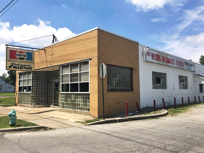 The unassuming exterior of The Workingman's Friend stands like a time capsule on Indy's west side. That vintage Pepsi sign has been guiding hungry patrons to burger bliss for decades.