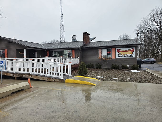 The unassuming exterior of The Cleveland Dog House hides culinary treasures within. Those red umbrellas beckon like beacons to hungry travelers.