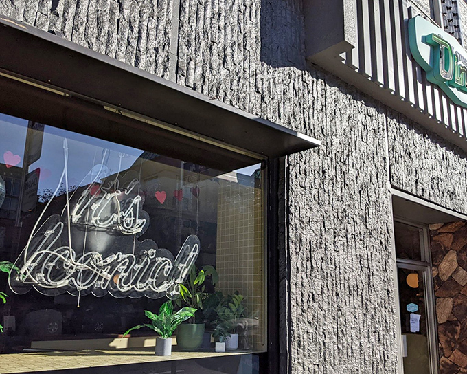The textured stone facade of Clark Street Diner whispers tales of Hollywood's golden era while that neon sign promises comfort food worth writing home about.