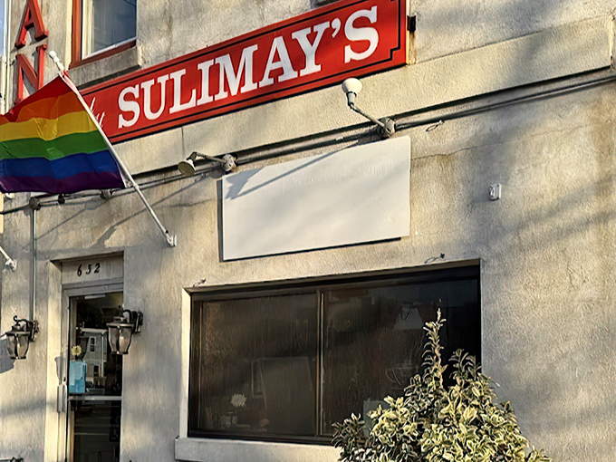 Sulimay's exterior welcomes you with old-school charm and a rainbow flag, promising both tradition and inclusivity in this Fishtown cornerstone.