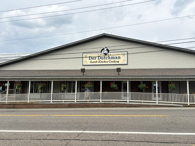 The white clapboard exterior of Der Dutchman welcomes visitors with hanging flower baskets and a front porch that practically whispers "come hungry, leave happy."