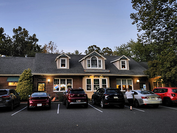 The charming brick exterior of Moccia's Train Stop welcomes hungry travelers with its cozy dormers and warm glow at dusk.