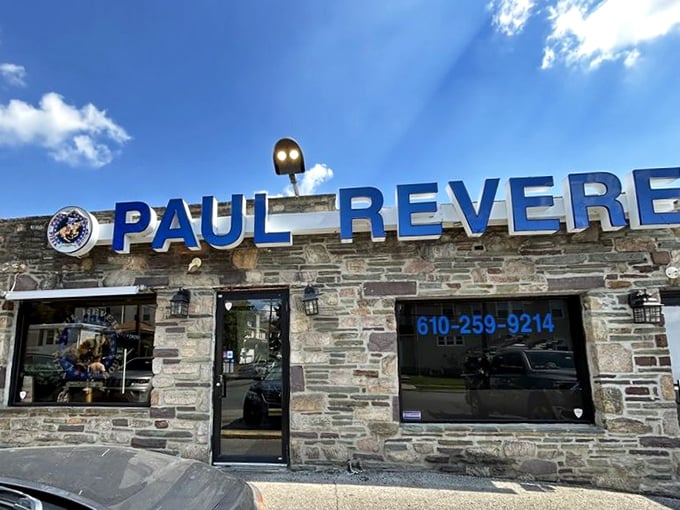 The stone fortress of flavor! Paul Revere Pizza House's iconic exterior stands as a Delaware County landmark, its blue lettering a beacon for hungry pizza pilgrims.