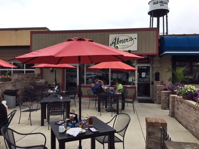 Abner's welcomes you with colorful umbrellas and flower-filled planters, creating the perfect outdoor oasis for sipping coffee and watching Hilliard wake up.