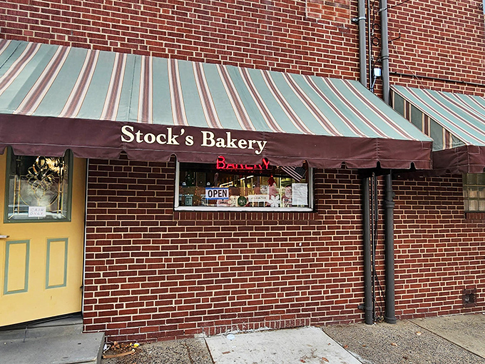 The unassuming brick exterior of Stock's Bakery hides Philadelphia's greatest pound cake secret behind that yellow door and vintage striped awning.