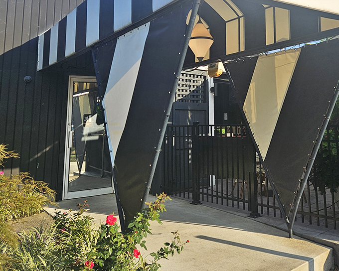 The geometric, mid-century modern entrance to The Top Steakhouse stands like a portal to another era—one where dinner was an event, not just a meal.