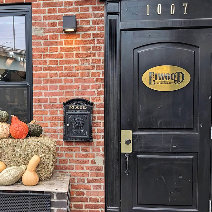 The unassuming entrance to culinary paradise &ndash; a black door with a golden Elwood plaque that promises treasures beyond the brick facade.
