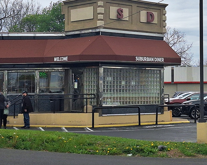 The iconic burgundy awning and glass block windows of Suburban Diner stand like a time portal to when calories didn't count and coffee refills were unlimited.