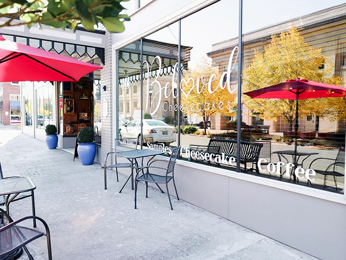 The storefront beckons with red umbrellas and promises of "Samples, Cheesecake, Coffee" – three magic words that could solve most of life's problems.