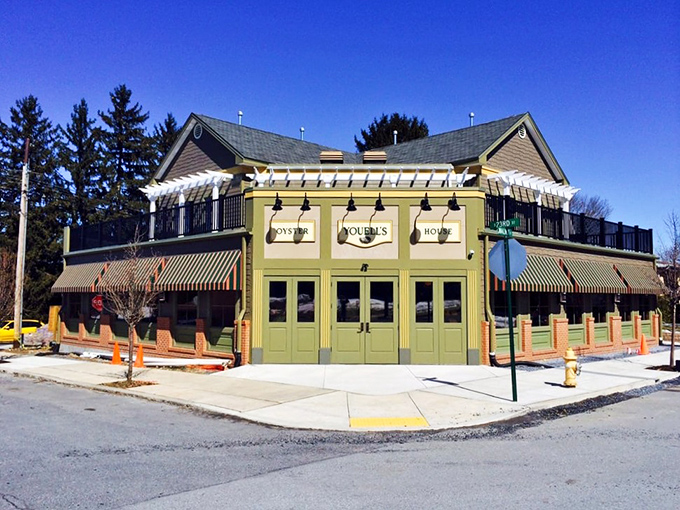 That charming green facade with cheerful awnings practically whispers "fresh seafood awaits inside these welcoming doors."