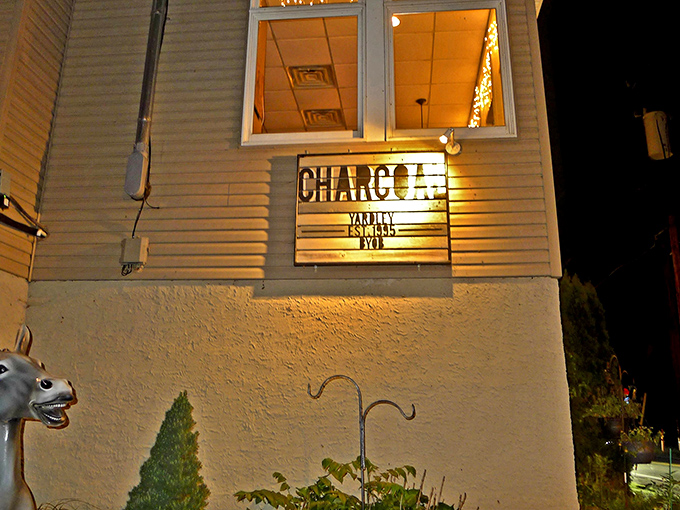 The unassuming exterior of Charcoal BYOB glows with promise as night falls, like a culinary lighthouse beckoning hungry travelers to safe harbor.